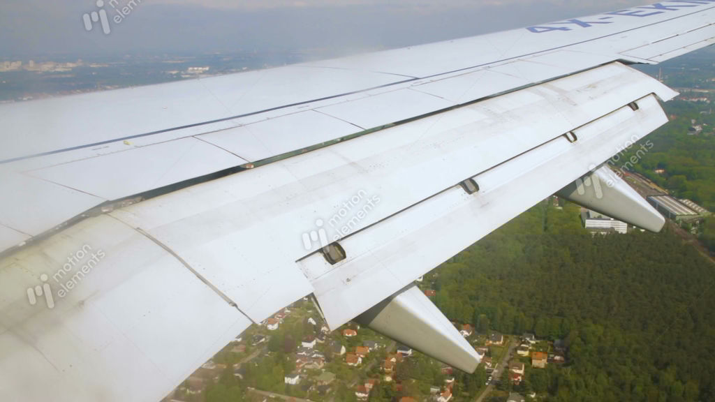Airplane Wing During Landing With Flaps Down On The Sky Over Land Stock ...